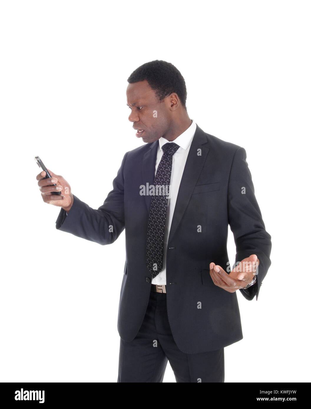 A tall African American buisessman looking at his cell phone in ...