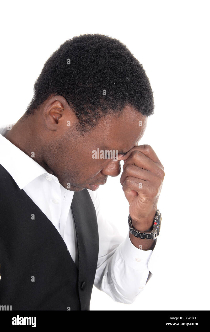 A close up of a frustrated young African American man looking down with ...