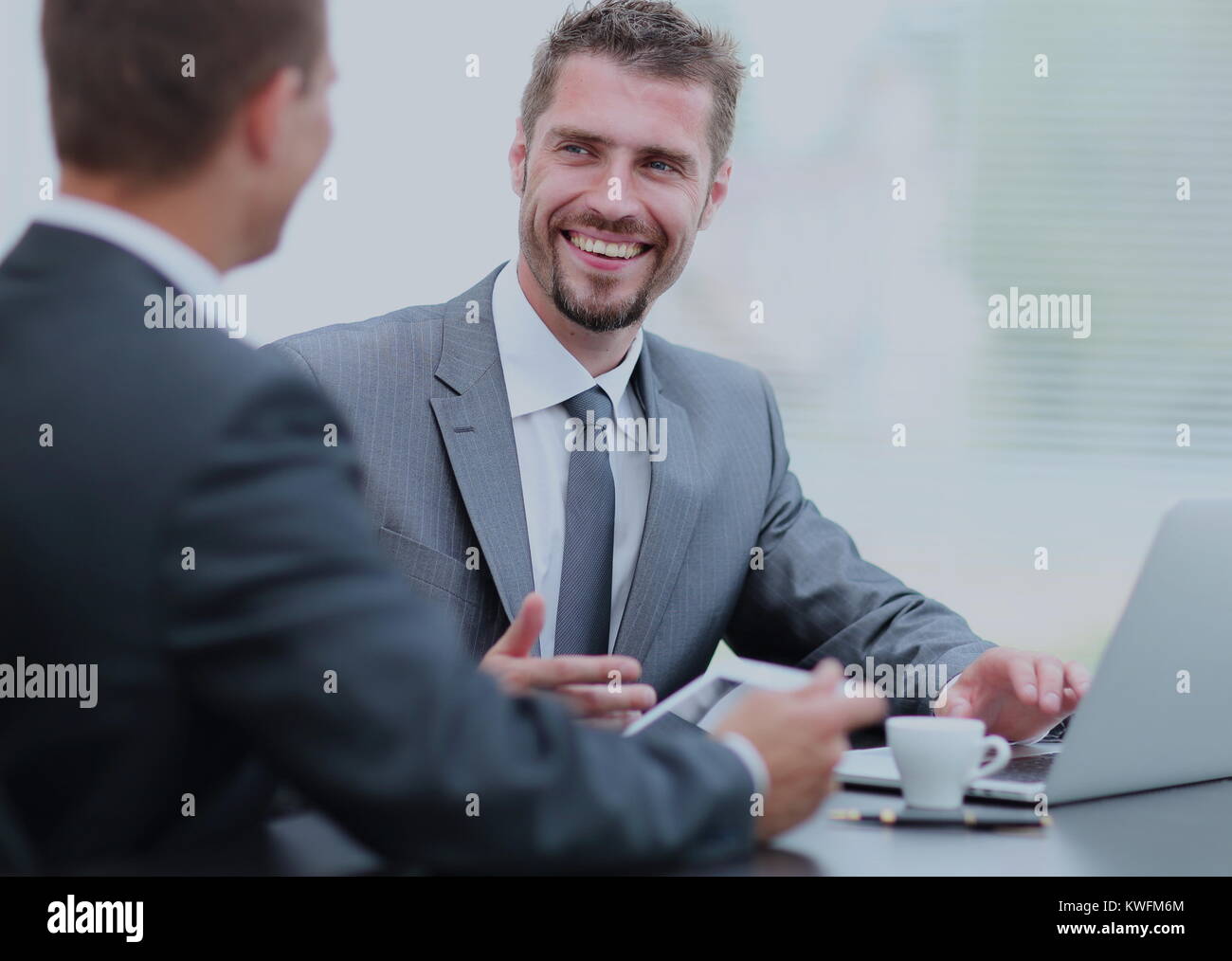 Business negotiations. Two colleagues talking in the office Stock Photo ...