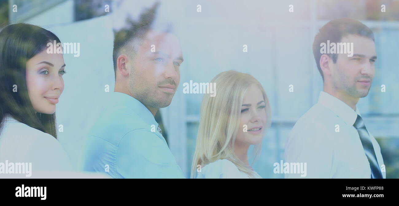 Happy smiling business team looking through window Stock Photo - Alamy