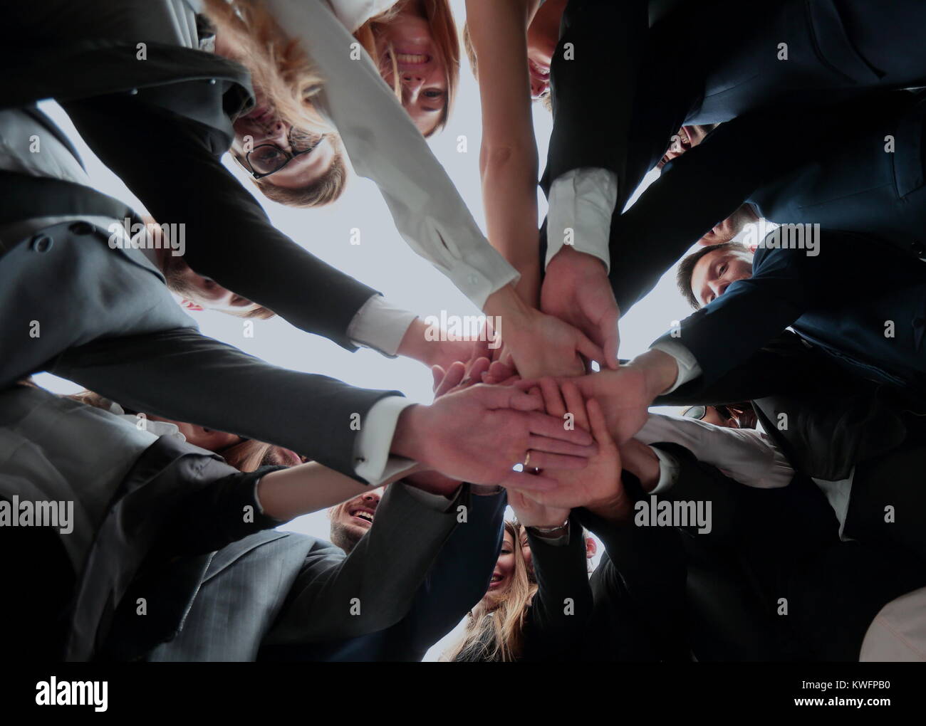 Large business team showing unity with their hands together Stock Photo - Alamy