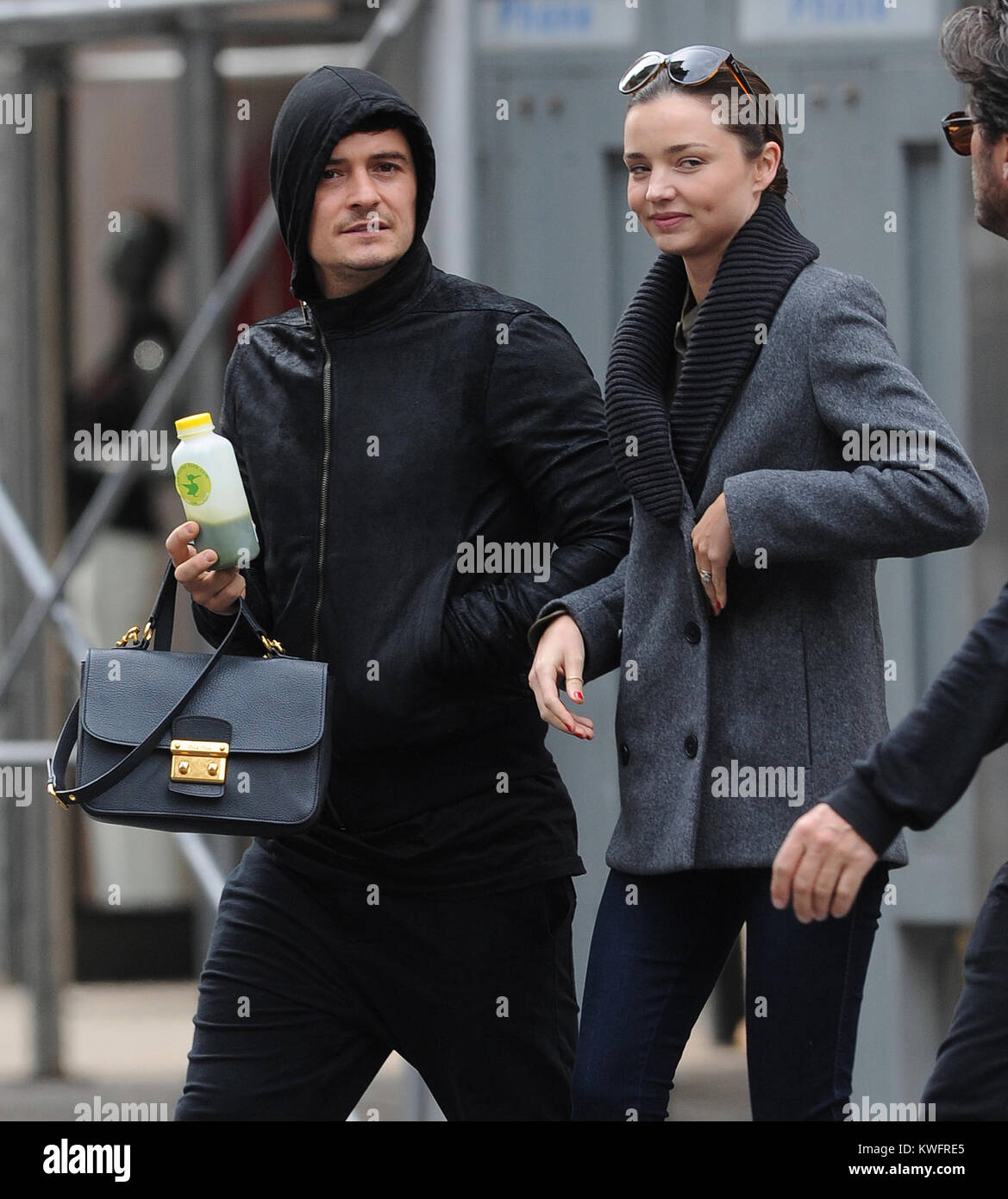 NEW YORK - OCTOBER 24: Orlando Bloom carries Miranda Kerr's purse while ...