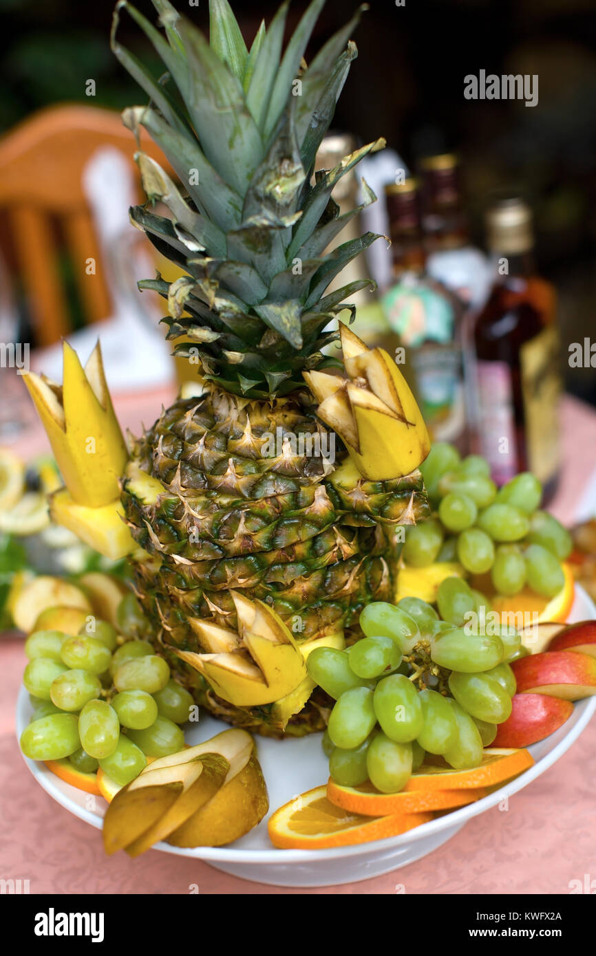 Pineapple and other fruits on cafe table Stock Photo - Alamy