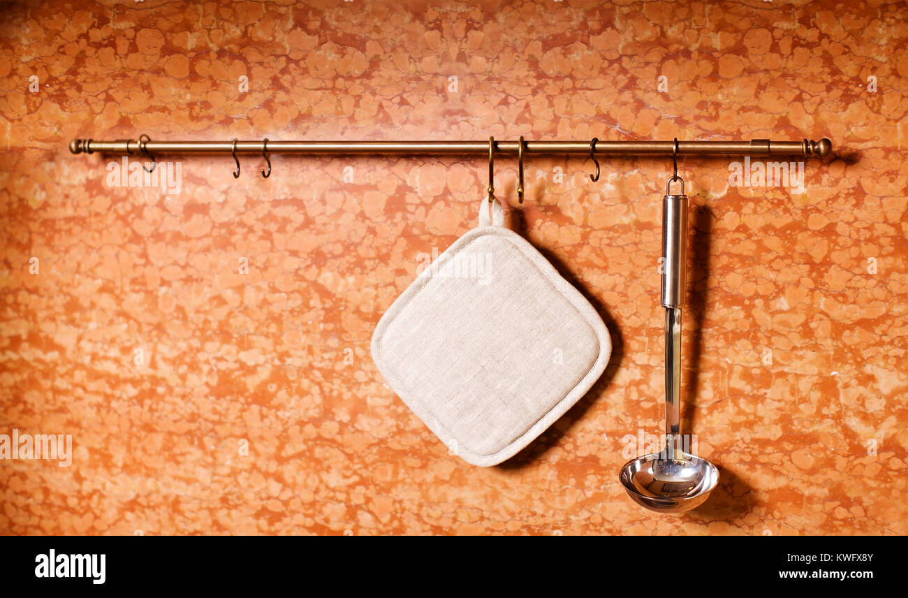 Tack and ladle hanging on kitchen wall close up Stock Photo - Alamy