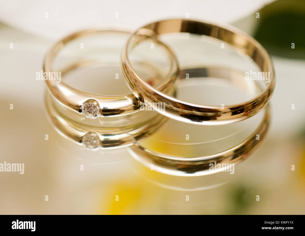 Two Golden Wedding Rings with diamond macro shot Stock Photo - Alamy