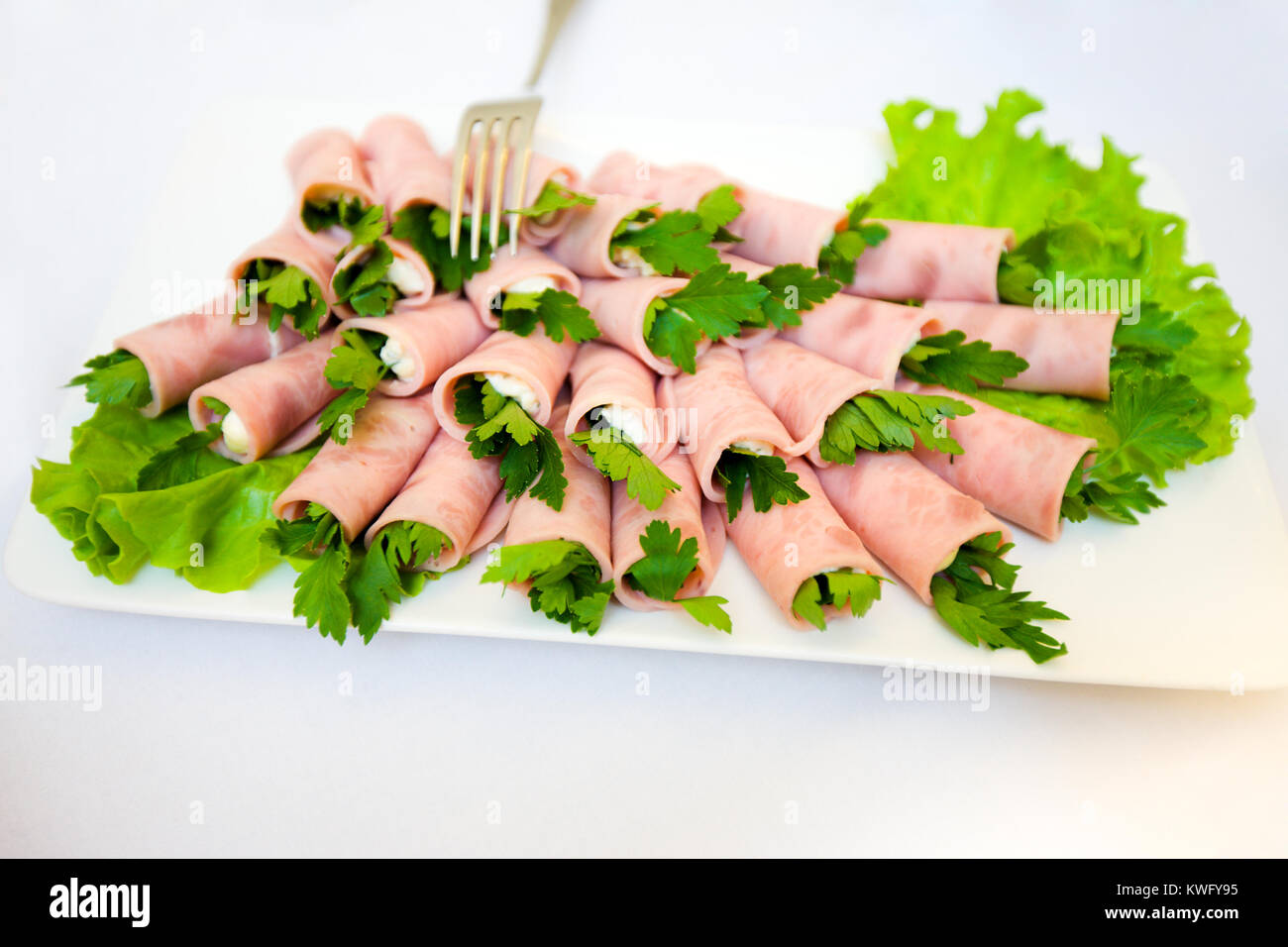 ham rolls on plate with lettuce macro shot Stock Photo - Alamy