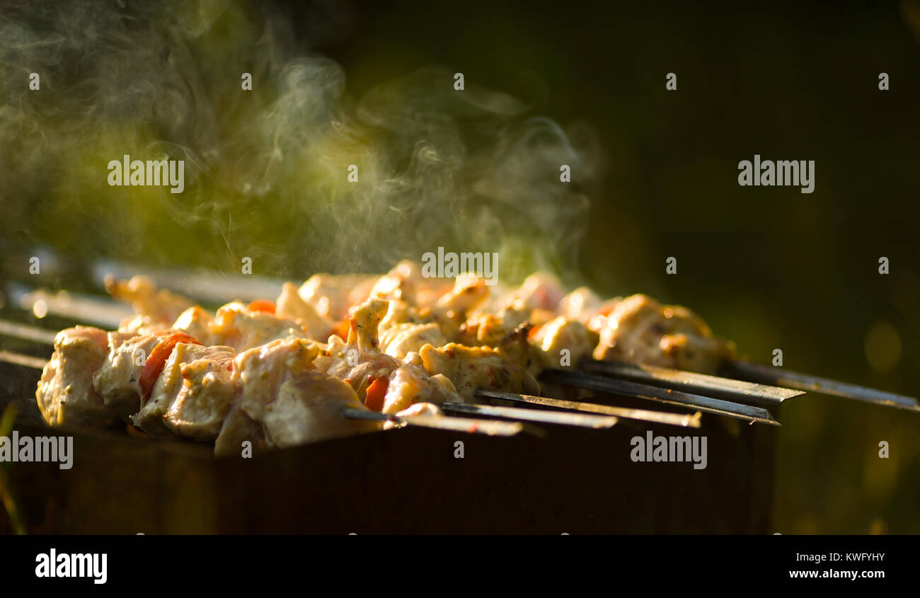 shish kebab in process of cooking on open fire outdoors Stock Photo - Alamy