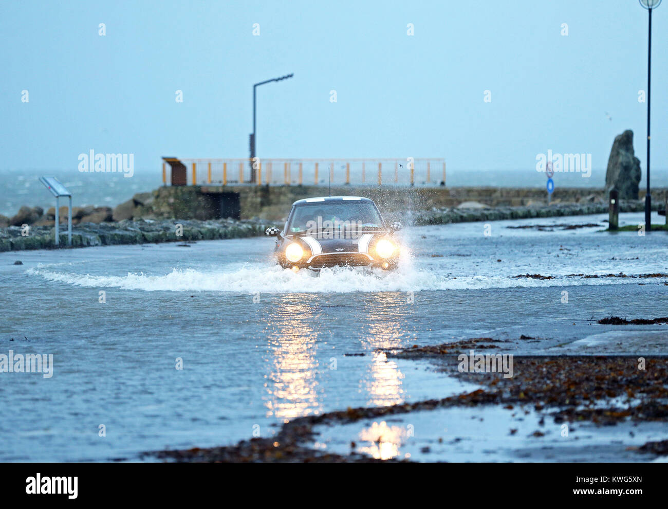 A car drives through a flooded car park in Salthill, Galway, as Storm ...