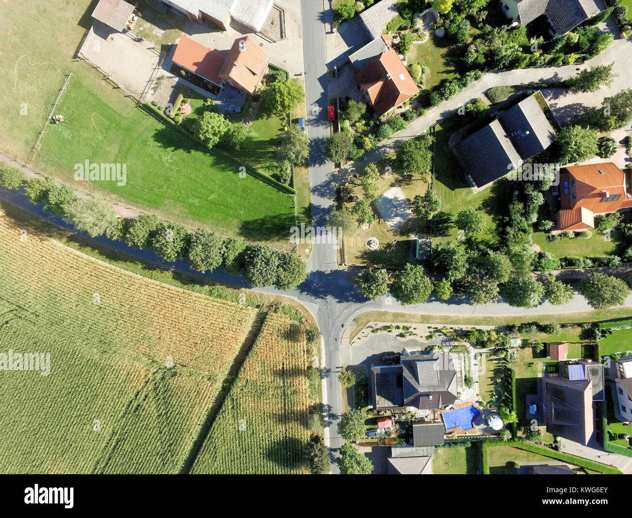 Aerial view from the edge of a village in Germany with a crossing and ...