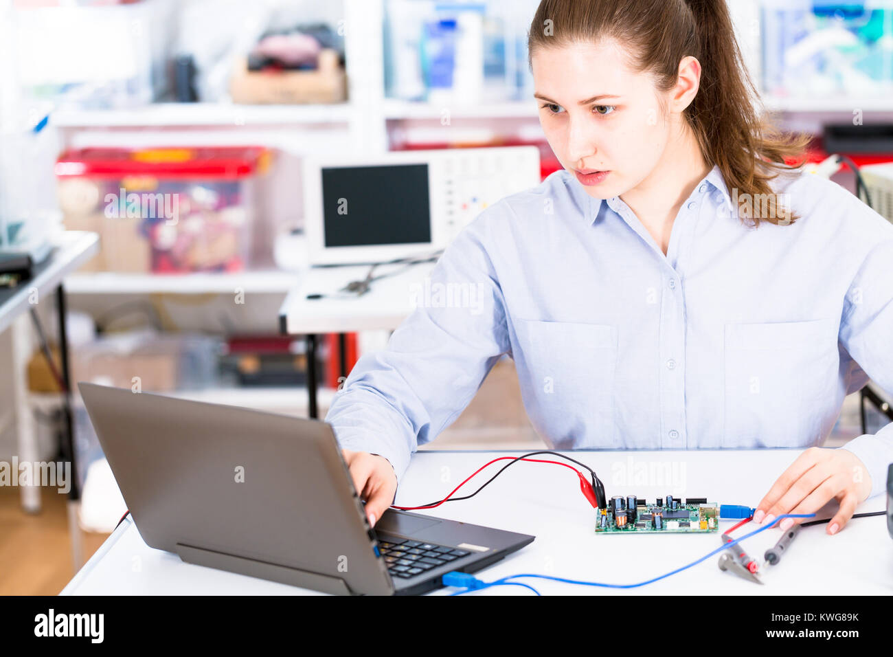 Young woman in electronics repair service center Stock Photo - Alamy