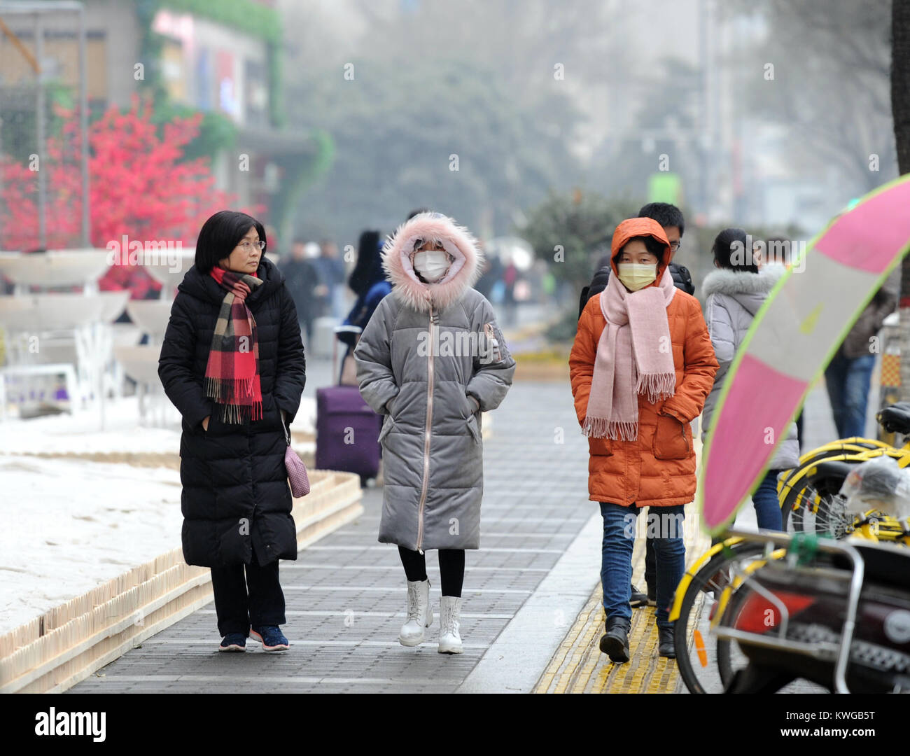 Xi'an, China's Shaanxi Province. 3rd Jan, 2018. Residents walk in snow ...