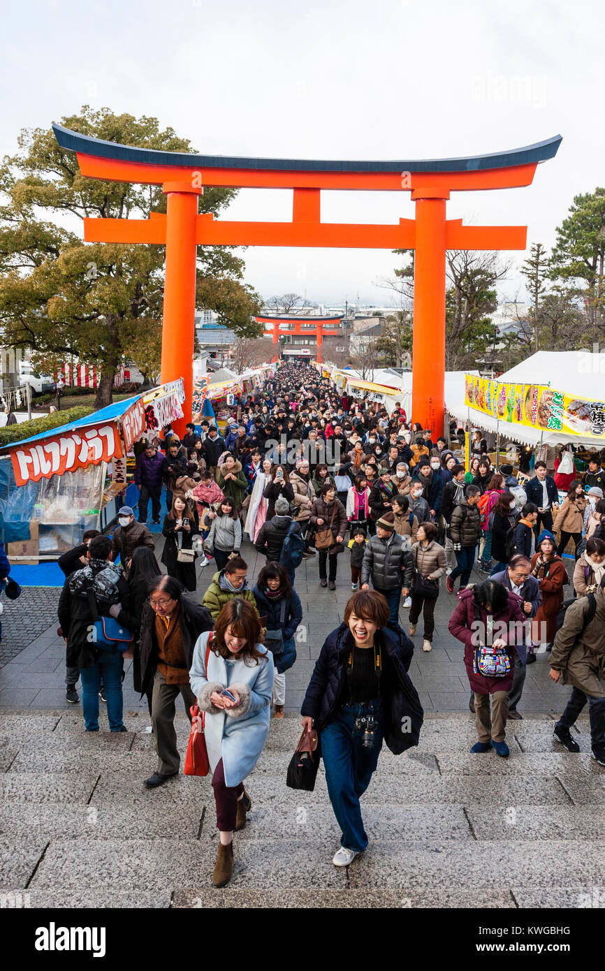 Japan, Kyoto, Yasaka shrine. Crowds of people walking along the road ...