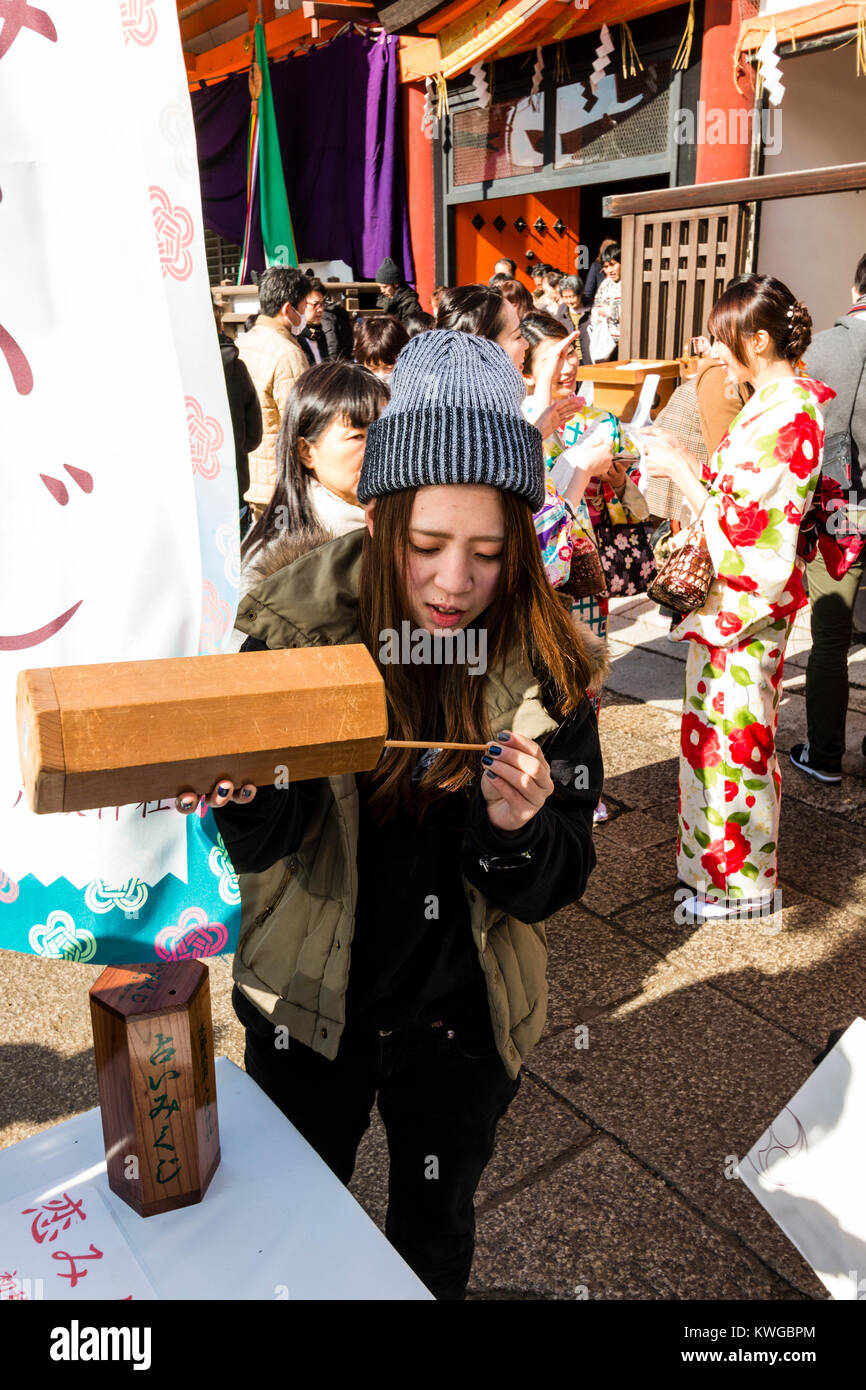 Japan, Kyoto, Yasaka Shinto shrine. Young woman during the New Year ...