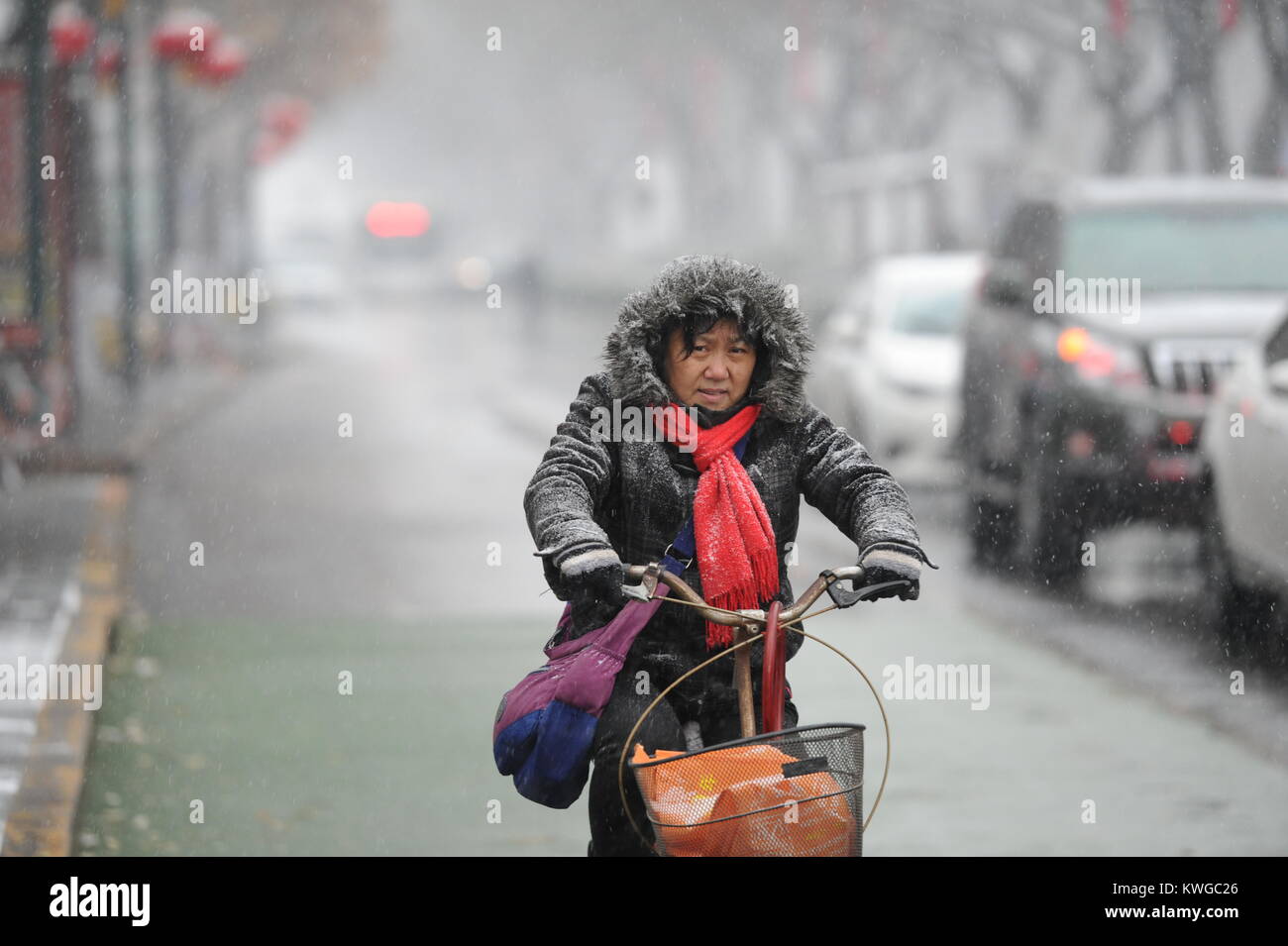 Xi'an, China's Shaanxi Province. 3rd Jan, 2018. A woman rides amid ...