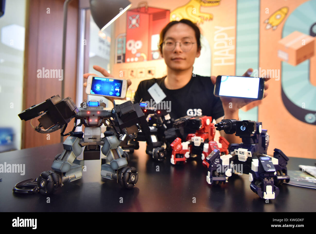Hong Kong, China. 3rd Jan, 2018. An exhibitor displays toy robots ...