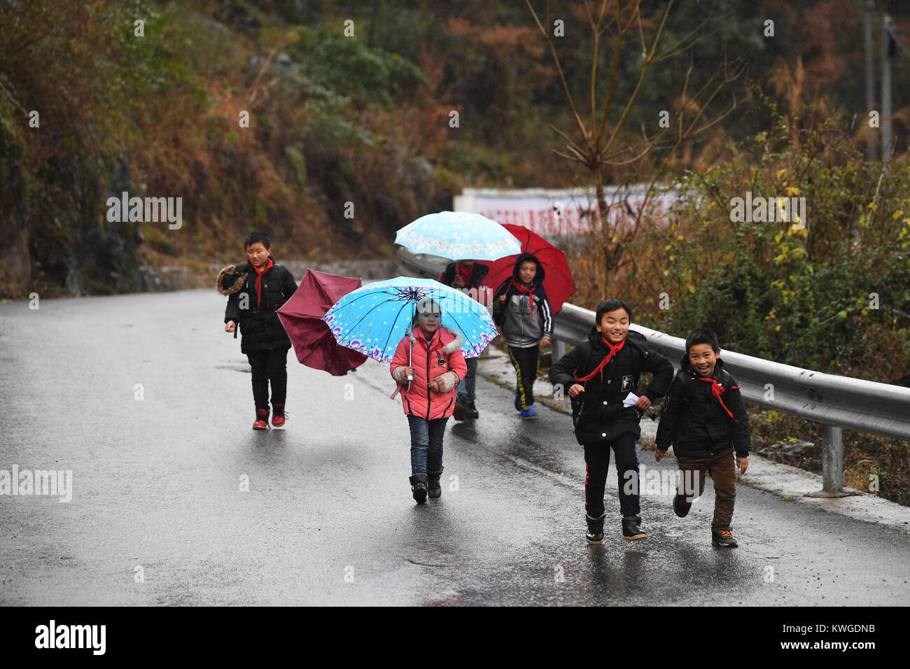 Chongqing, China's Chongqing City. 3rd Jan, 2018. Pupils walk on road ...