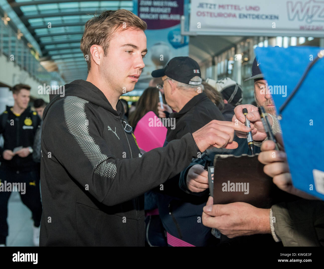 Dortmund's Mario Goetze gives autographs to fans before the departure ...