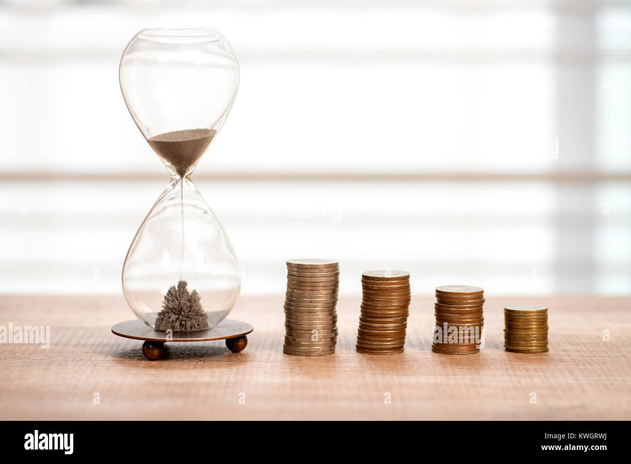 Deadline and time is money concept with hourglass Stock Photo - Alamy