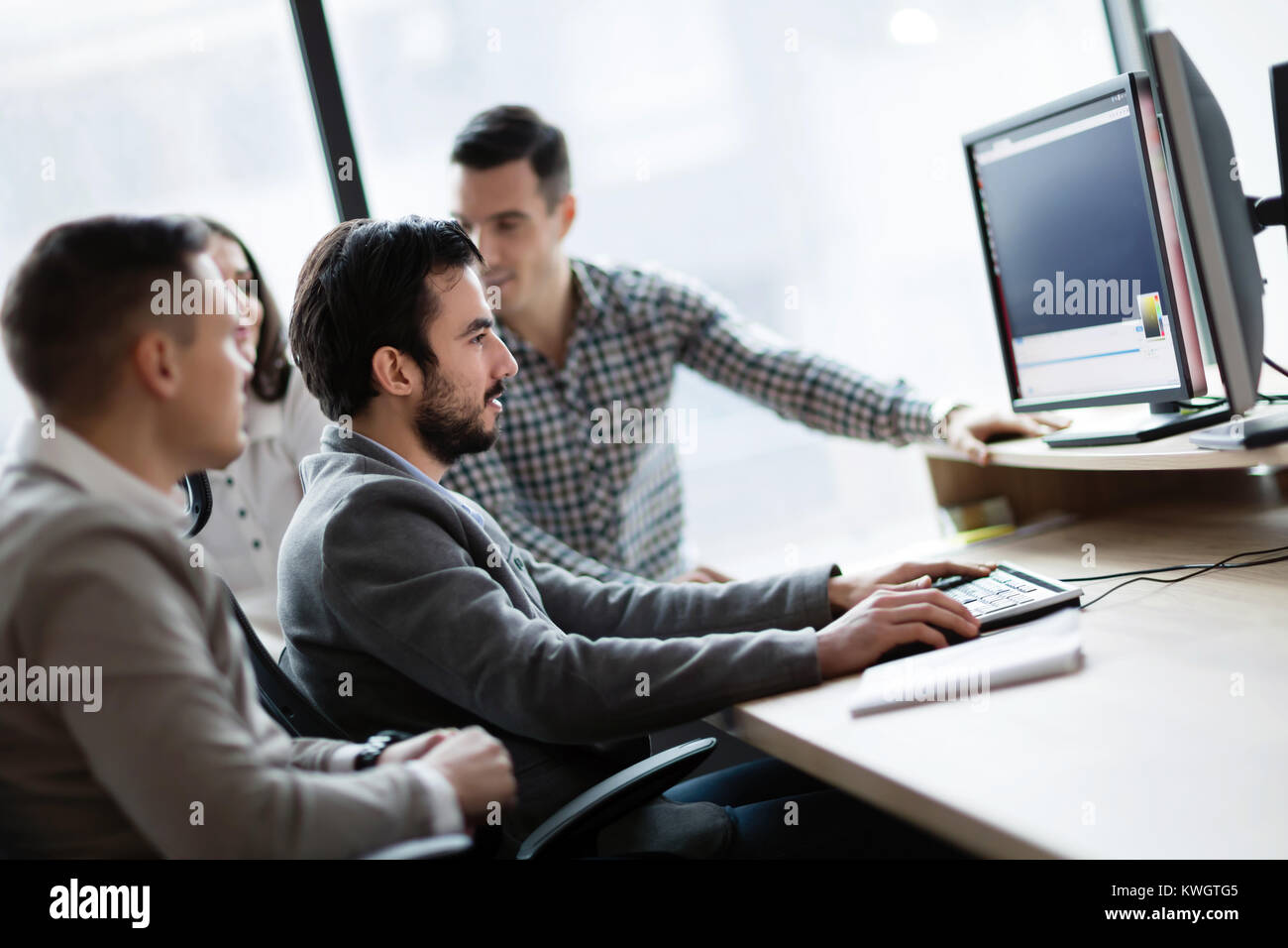 Young businesspeople working on computer in office Stock Photo - Alamy