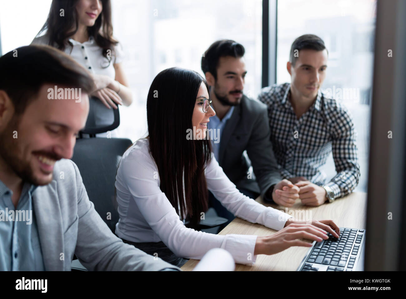 Young businesspeople working on computer in office Stock Photo - Alamy
