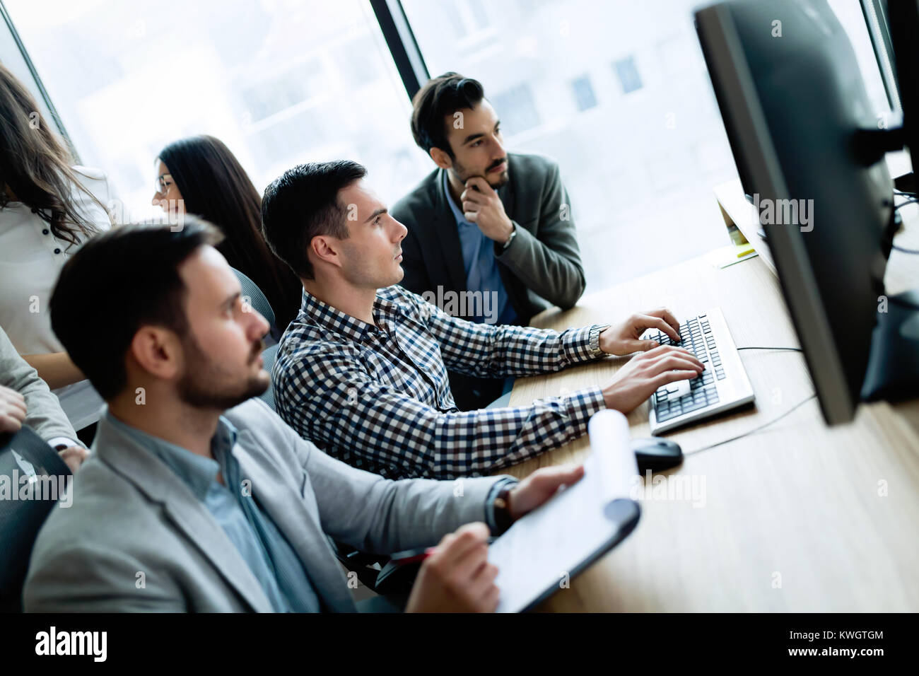 Young businesspeople working on computer in office Stock Photo - Alamy