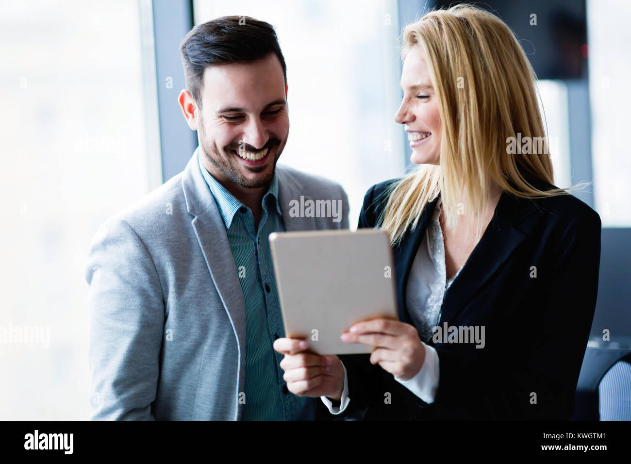 Attractive business couple using tablet in their company Stock Photo ...