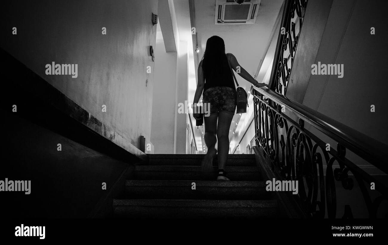 A Girl walking upstairs of a Haunted House Stock Photo - Alamy