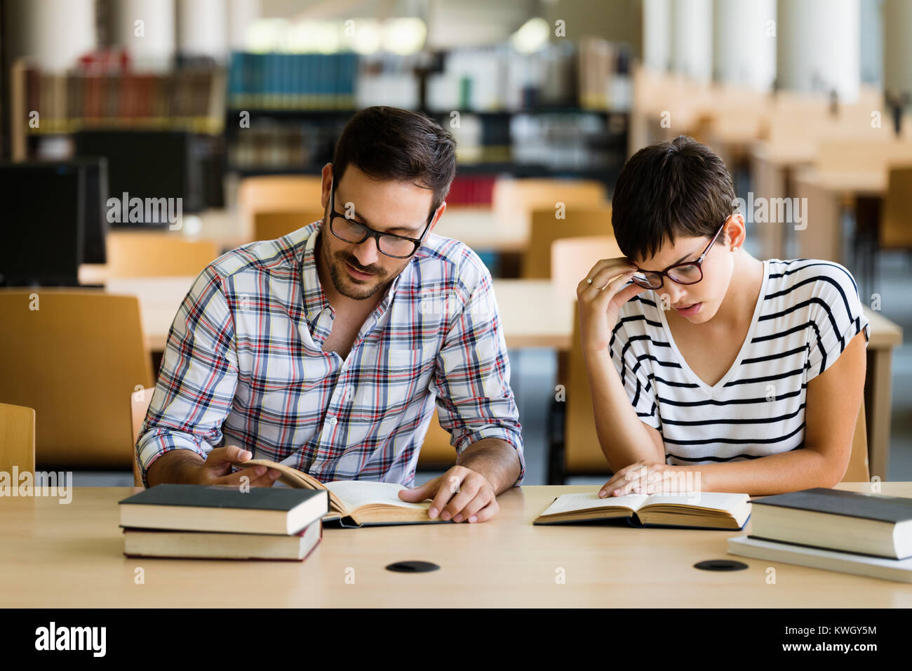 Group of college students studying at library Stock Photo - Alamy