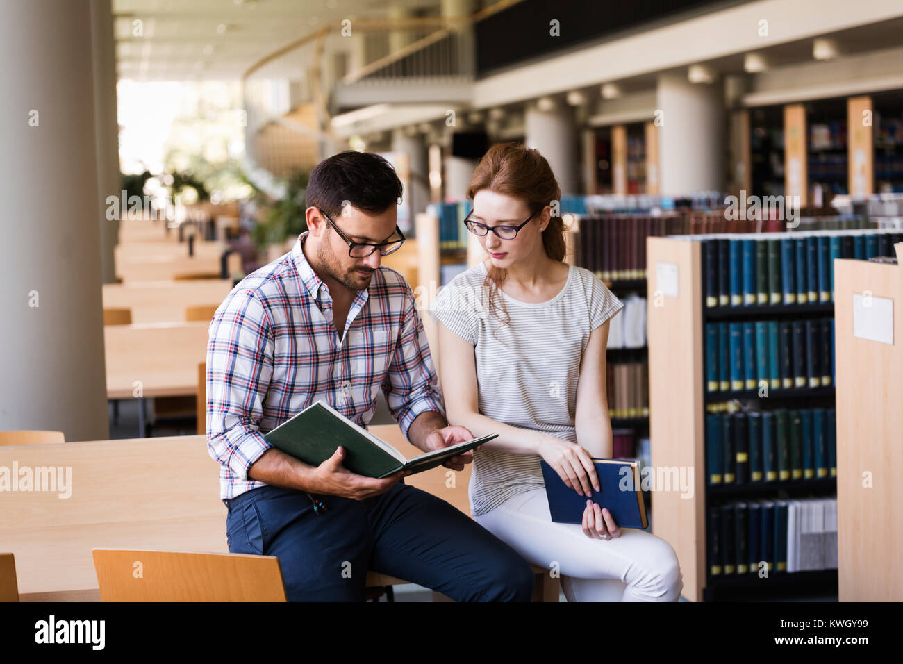 Group of college students at the library Stock Photo - Alamy