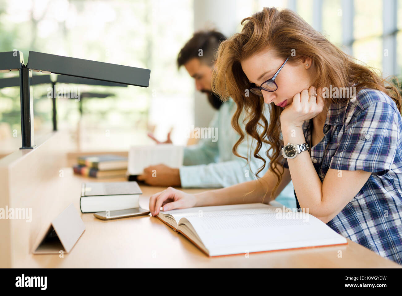 Young students studying in library Stock Photo - Alamy