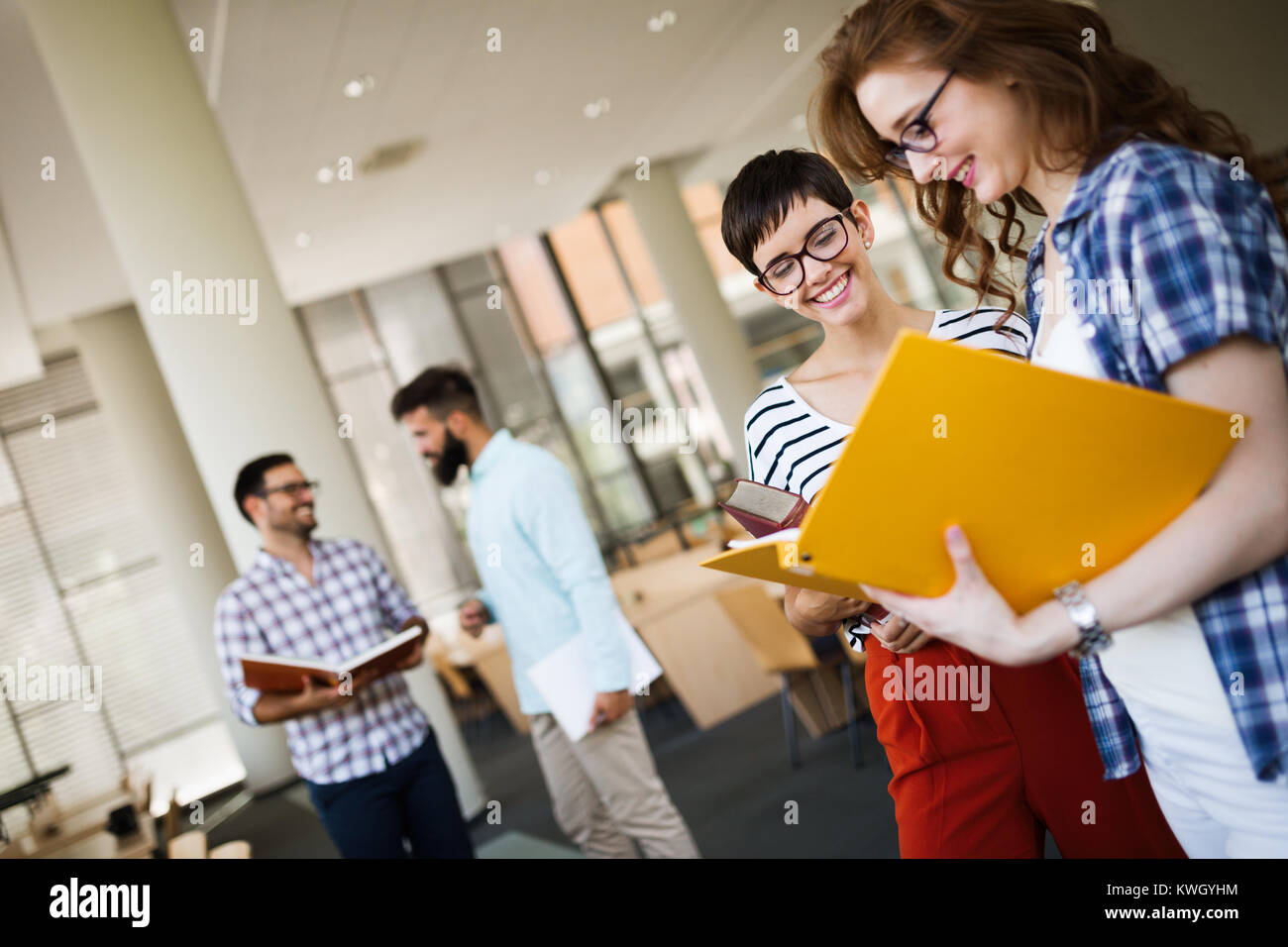 Group of college students studying at library Stock Photo - Alamy