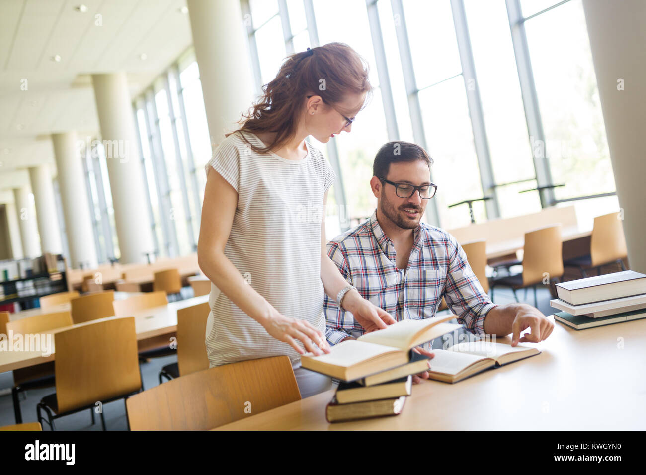 Young students studying in library Stock Photo - Alamy