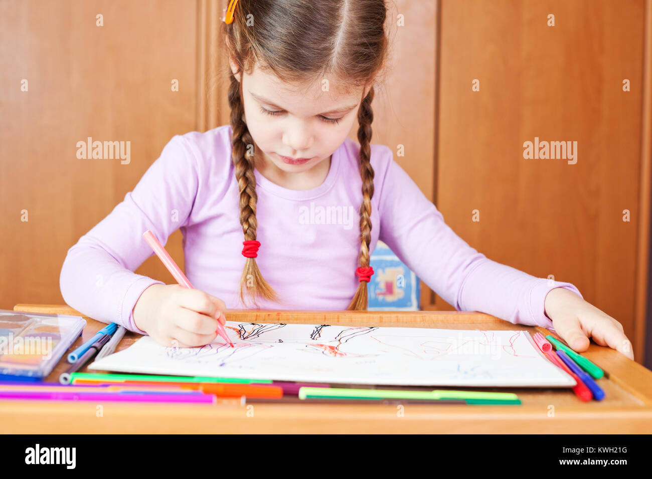 Preschooler child drawing in her room Stock Photo - Alamy