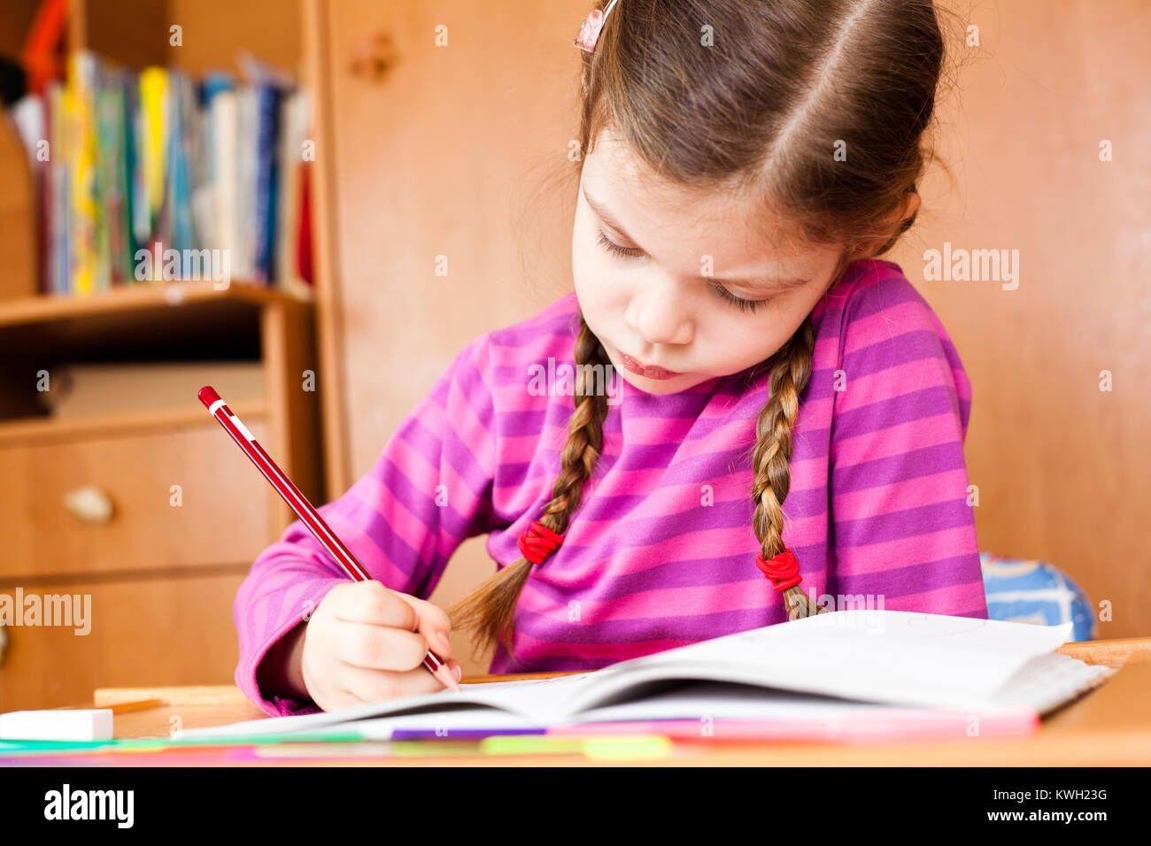 Preschooler child drawing in her room Stock Photo - Alamy