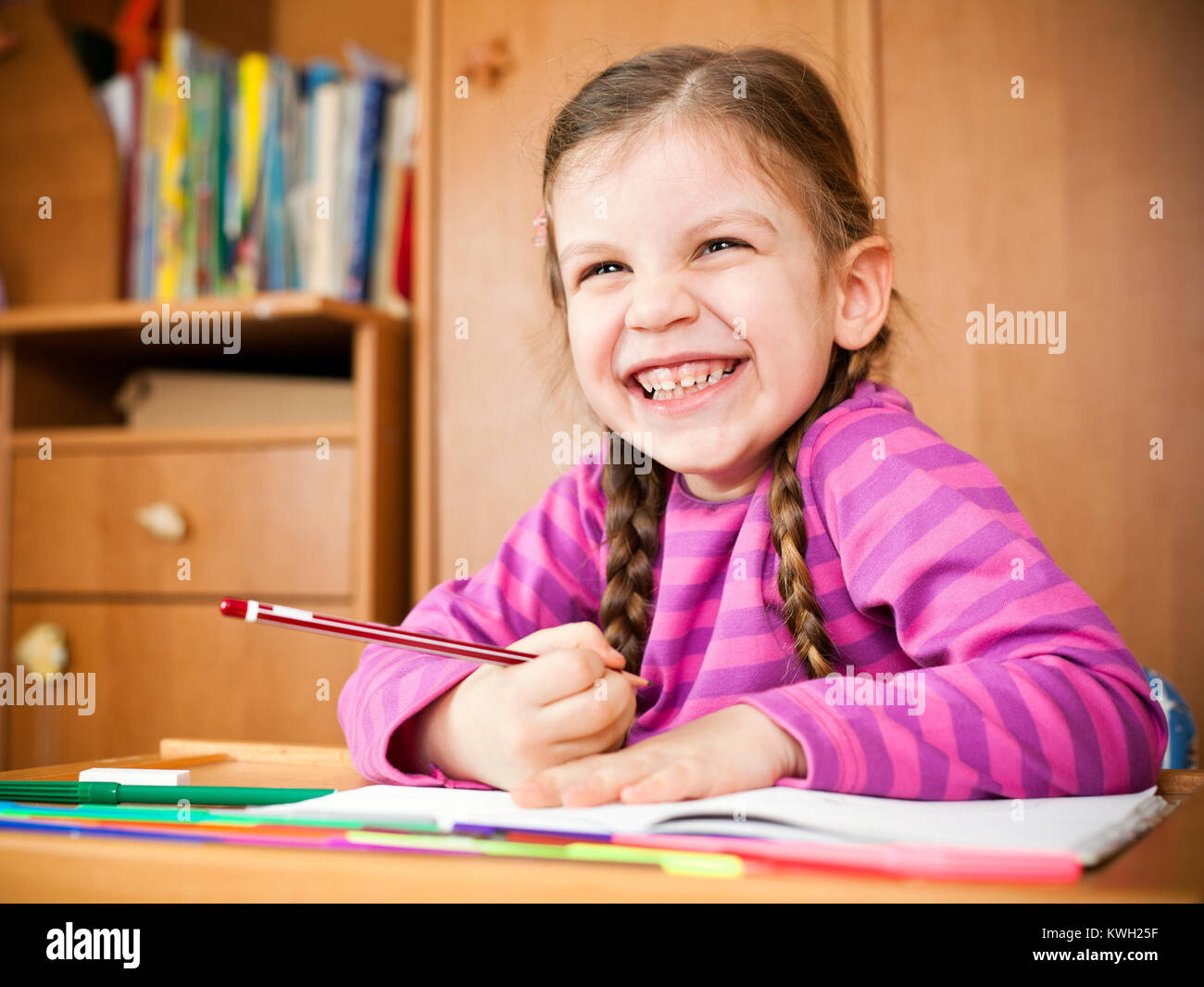 Preschooler child drawing in her room Stock Photo - Alamy