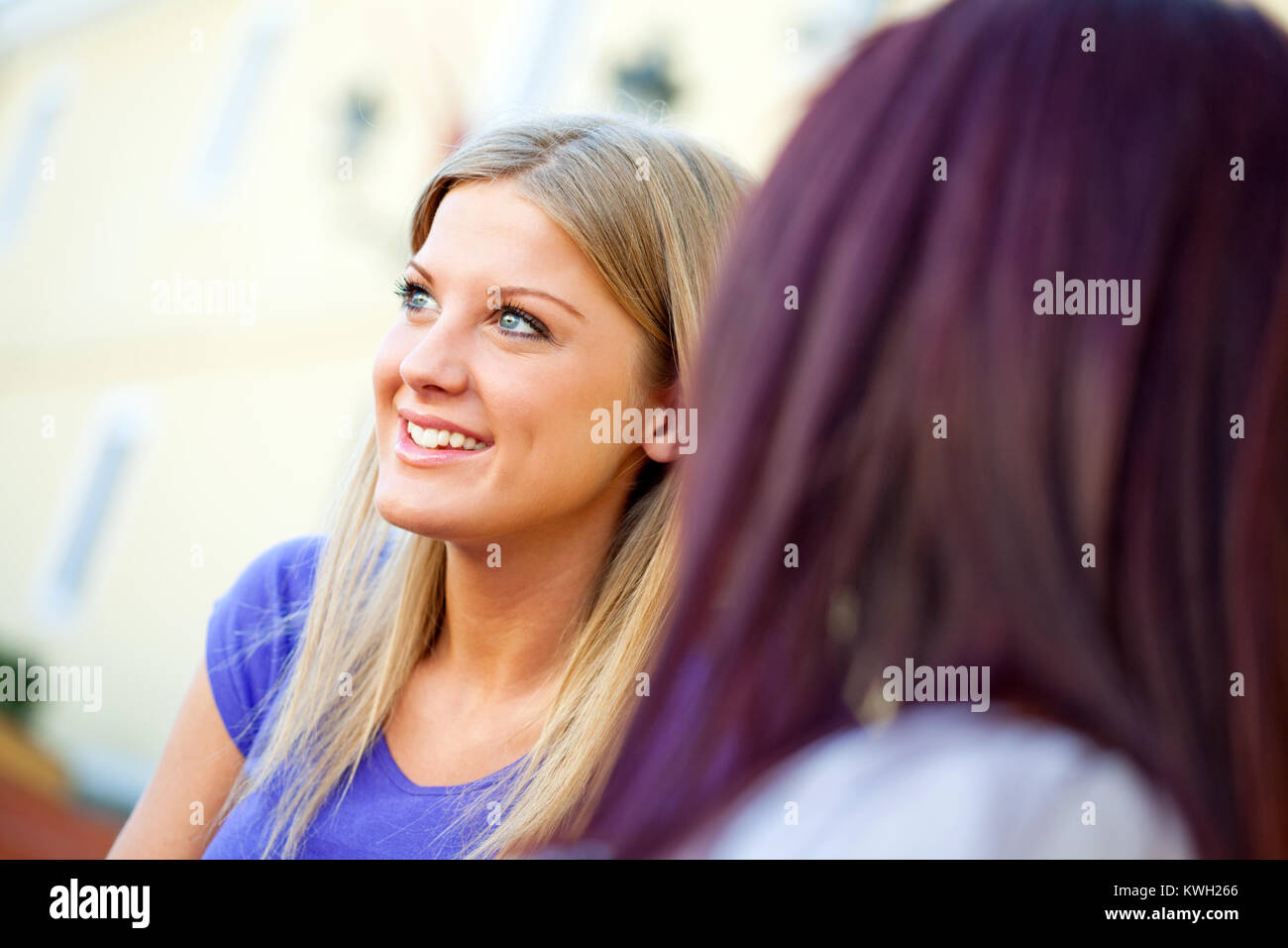 Two friends talking Stock Photo - Alamy