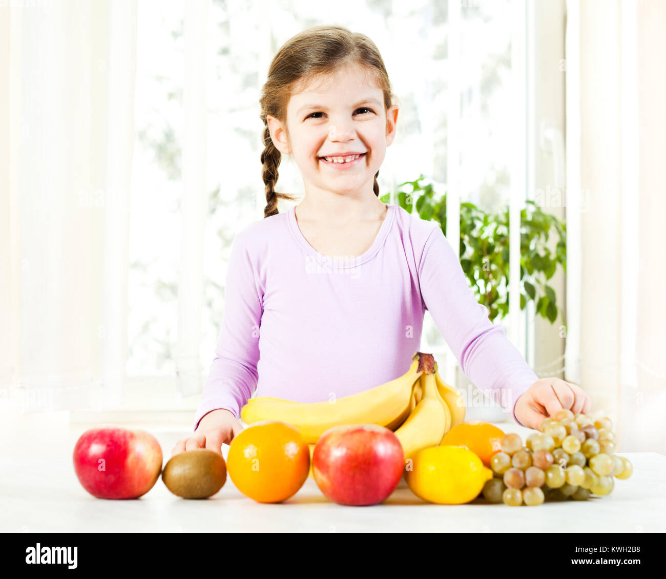Happy child with fruit Stock Photo - Alamy