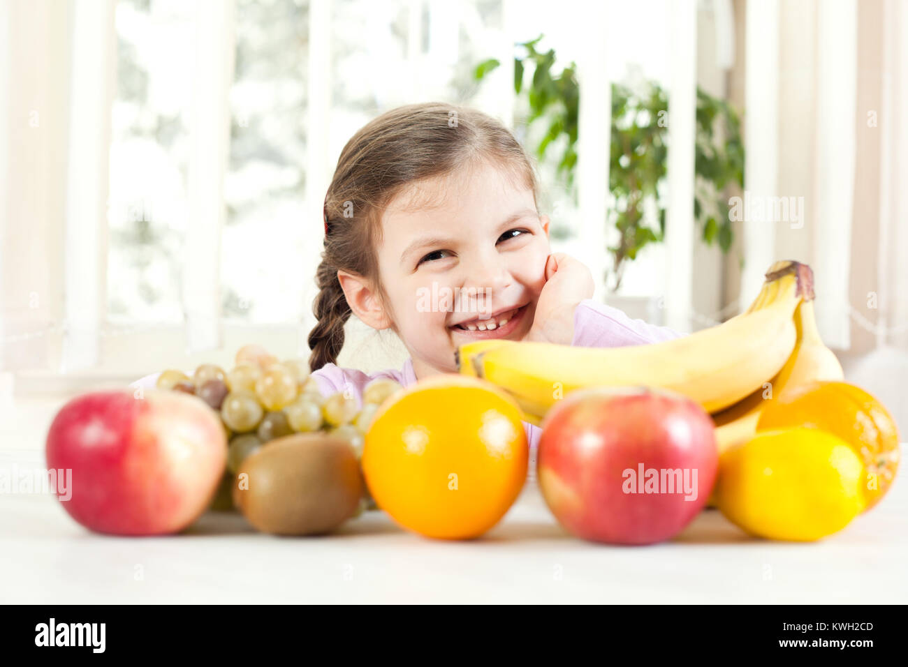 Happy child with fruit Stock Photo - Alamy