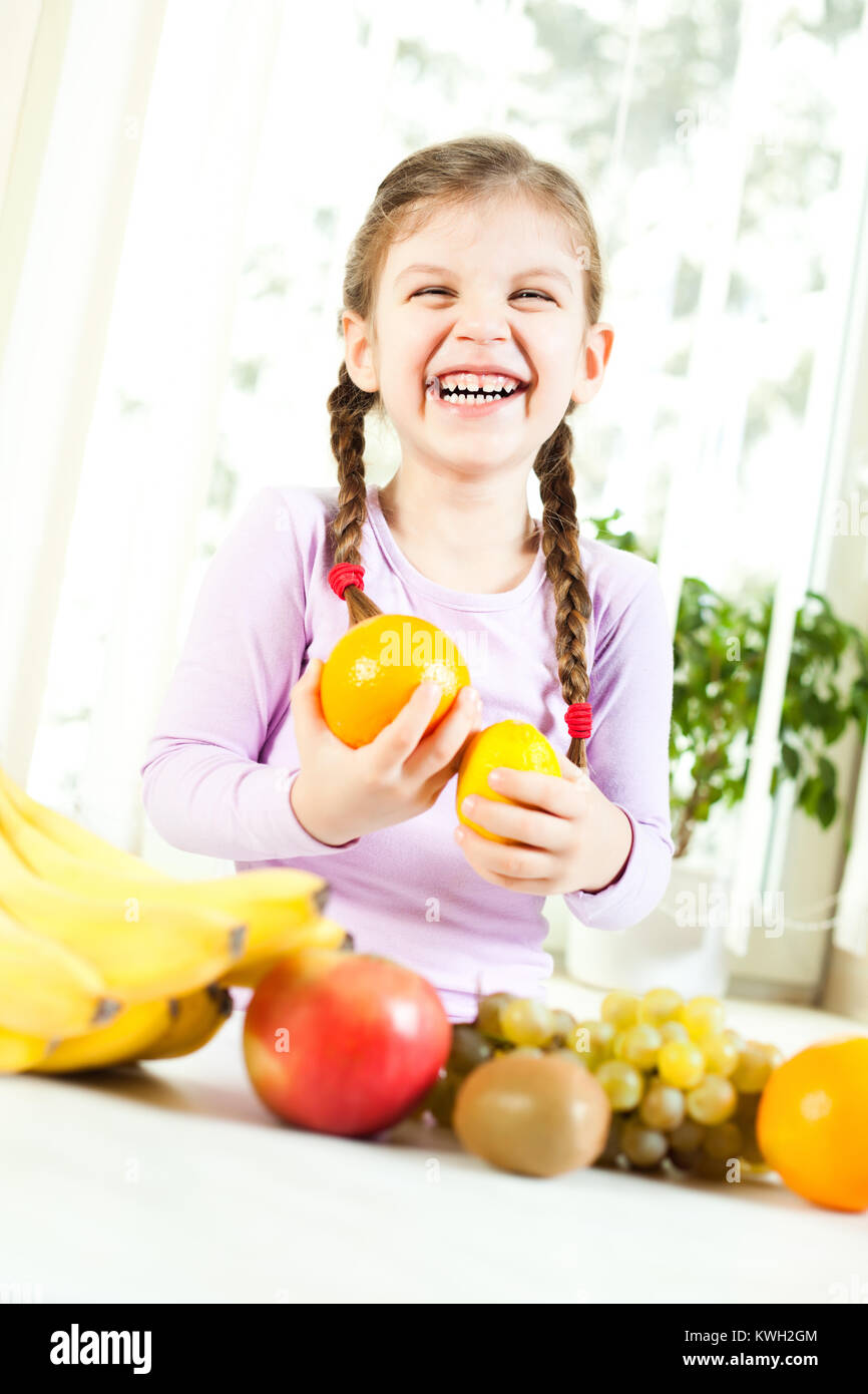 Happy child with fruit Stock Photo - Alamy