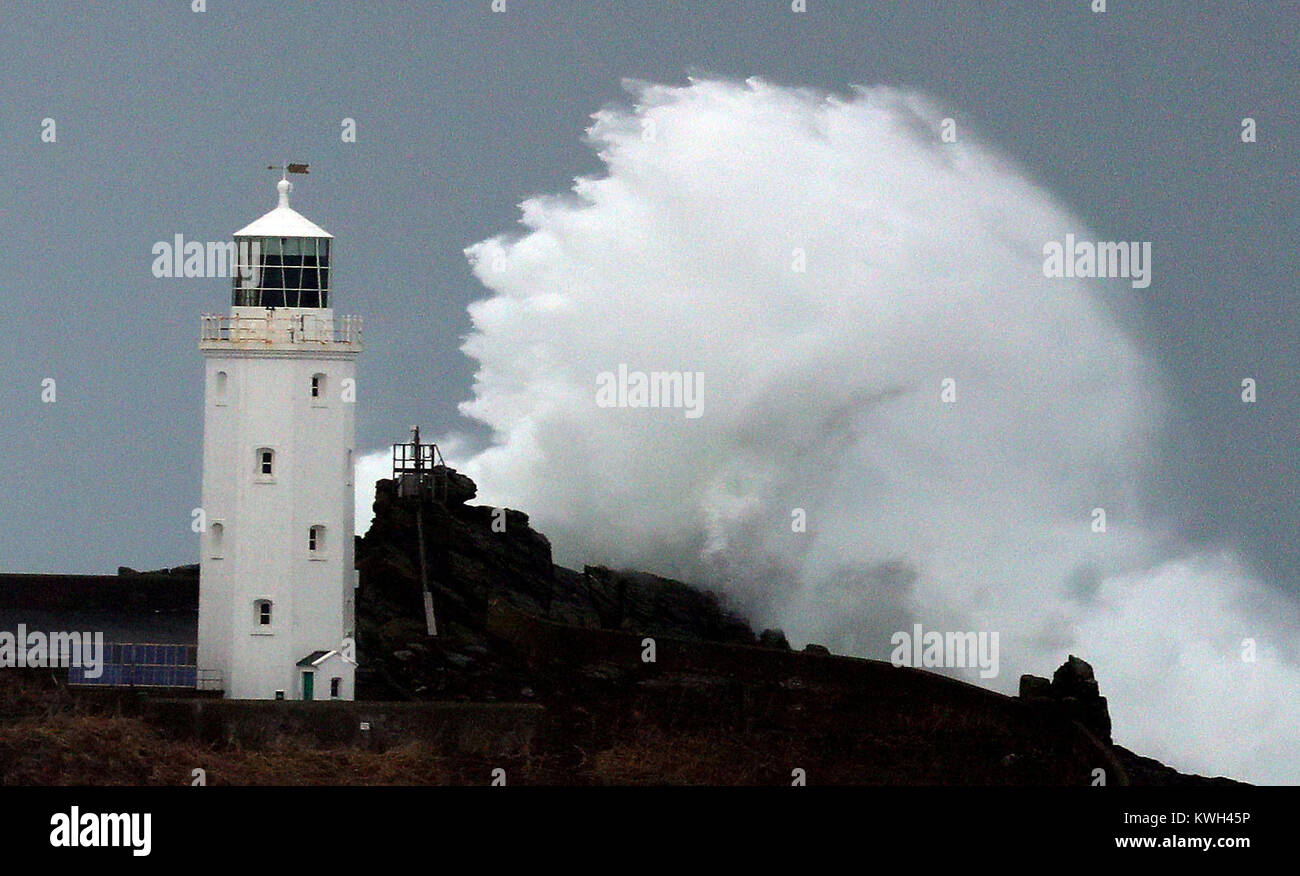 Waves crash against Godrevy Lighthouse on Godrevy Island in St Ives Bay ...