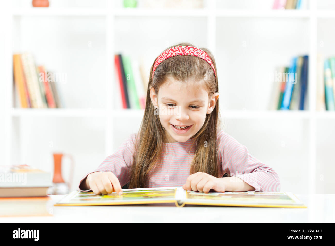 Happy child reading a book Stock Photo - Alamy