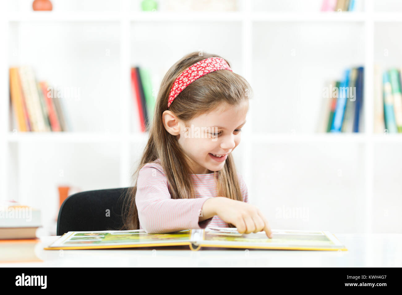 Happy child reading a book Stock Photo - Alamy