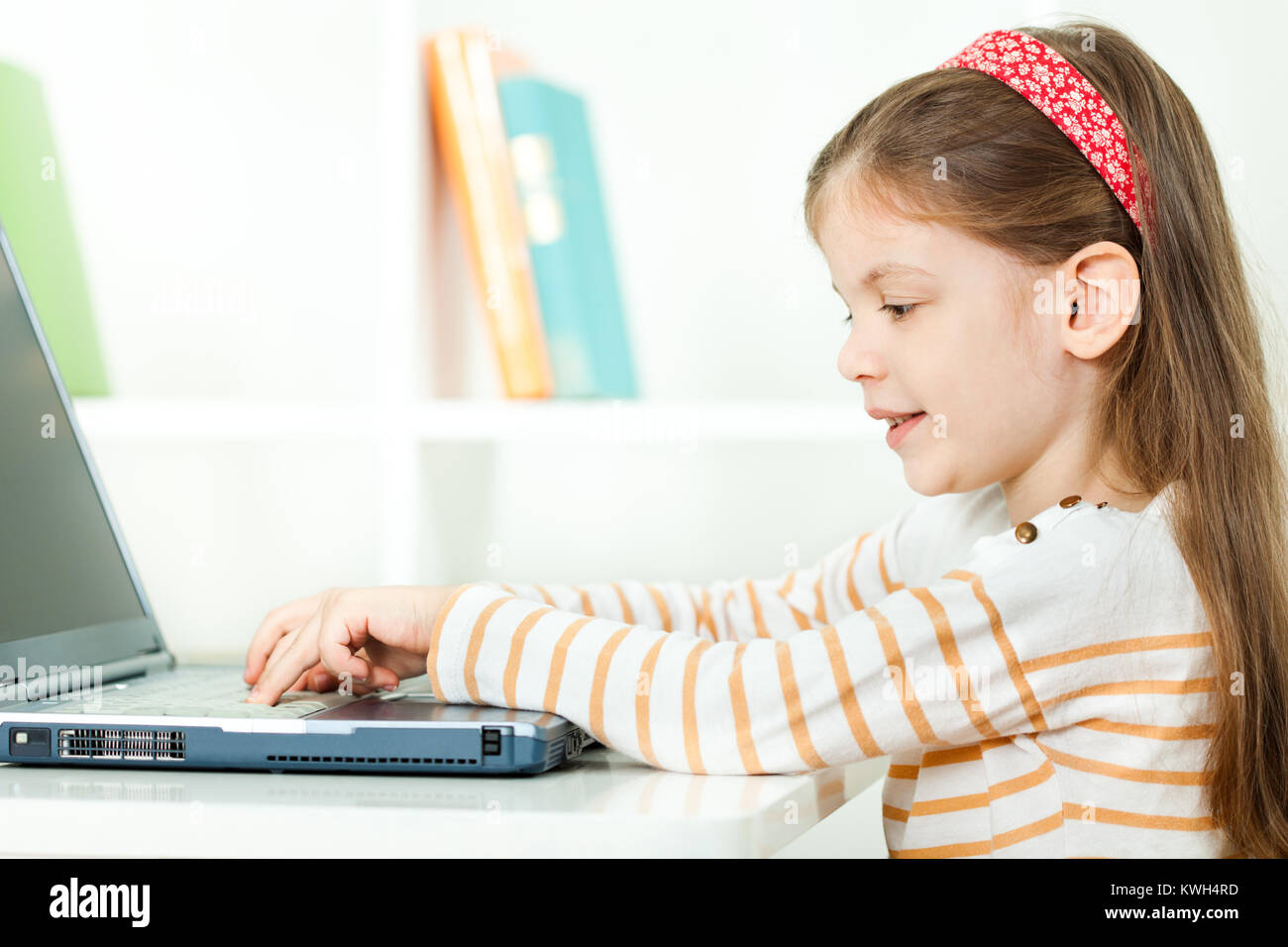 Child using laptop at home Stock Photo - Alamy