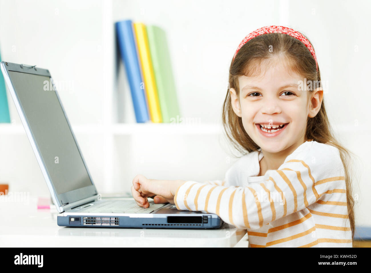 Child using laptop at home Stock Photo - Alamy
