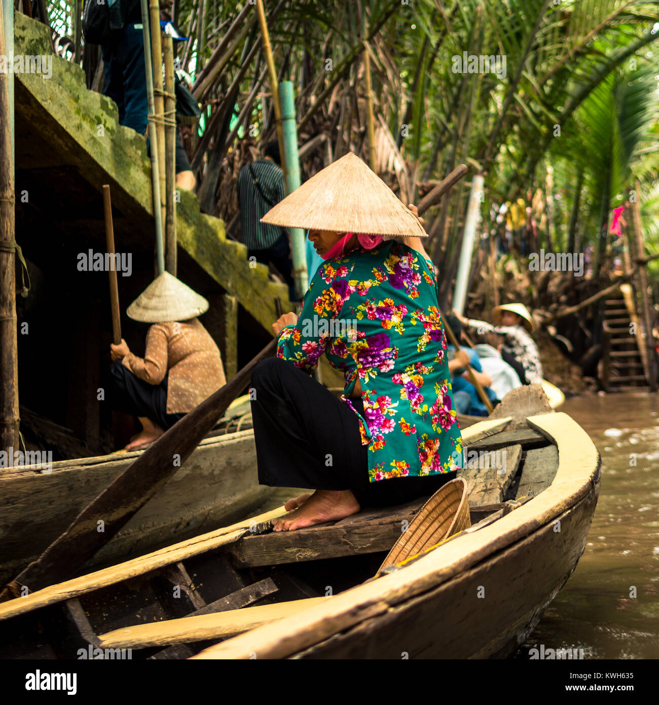 Vietnamese woman rowing a river boat Stock Photo - Alamy