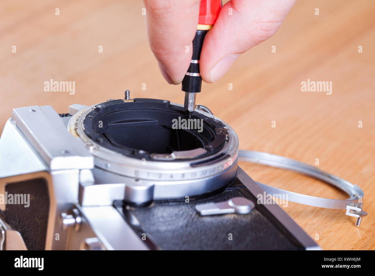 Technician repairing old photo camera Stock Photo - Alamy