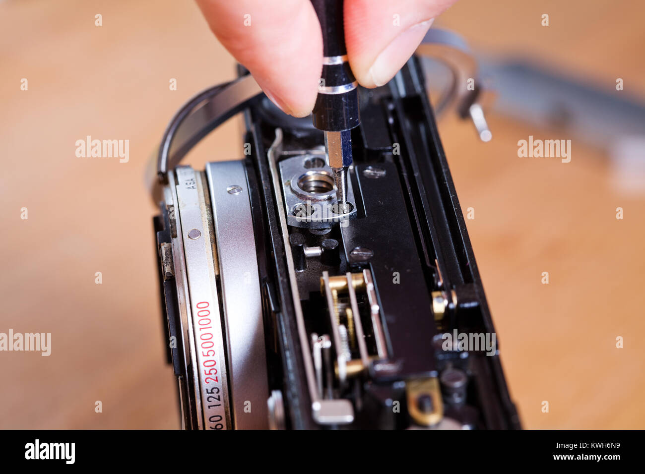Technician repairing old photo camera Stock Photo - Alamy
