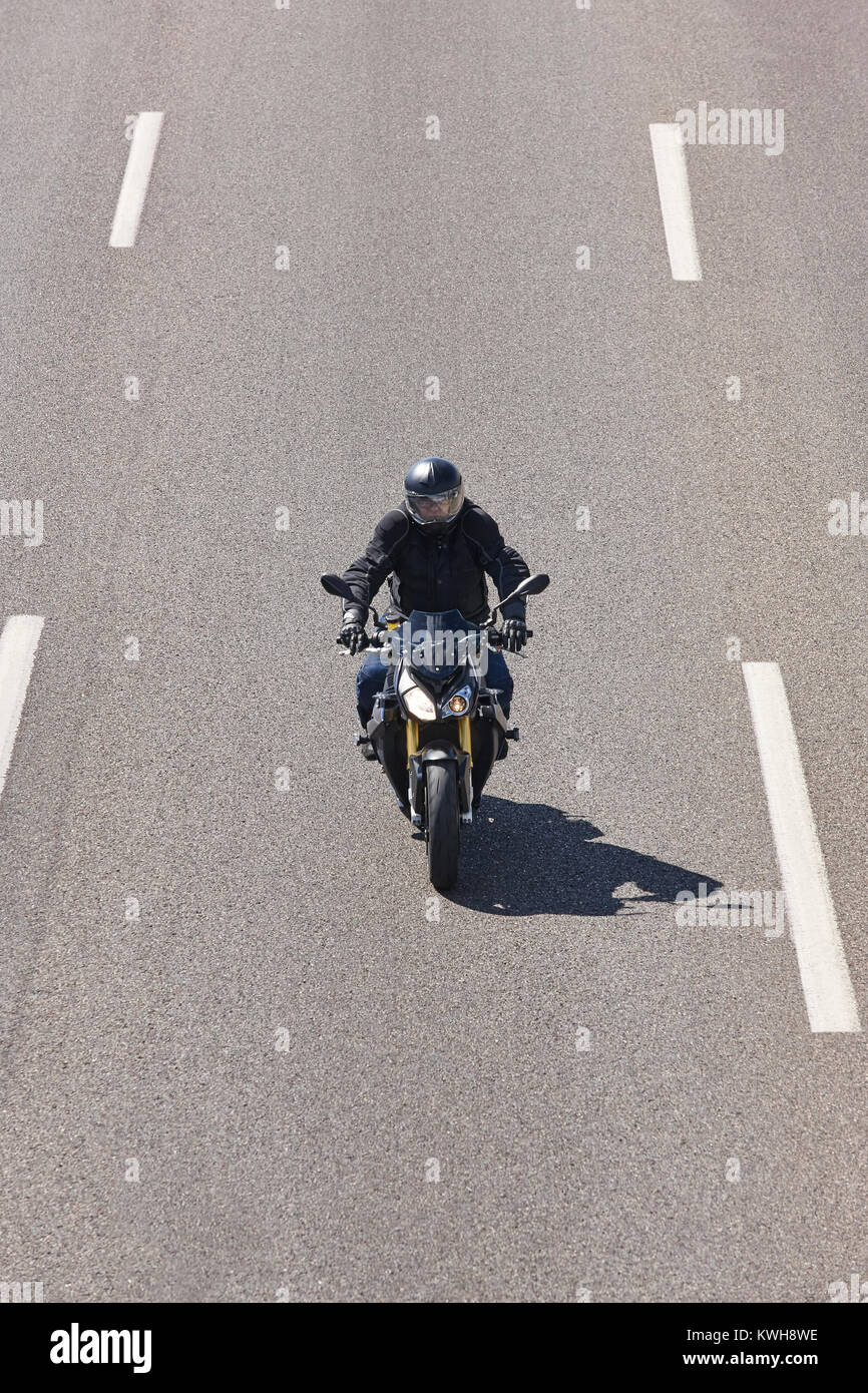 Motorcycle rider on the road. Travel and fun background. Vertical Stock ...