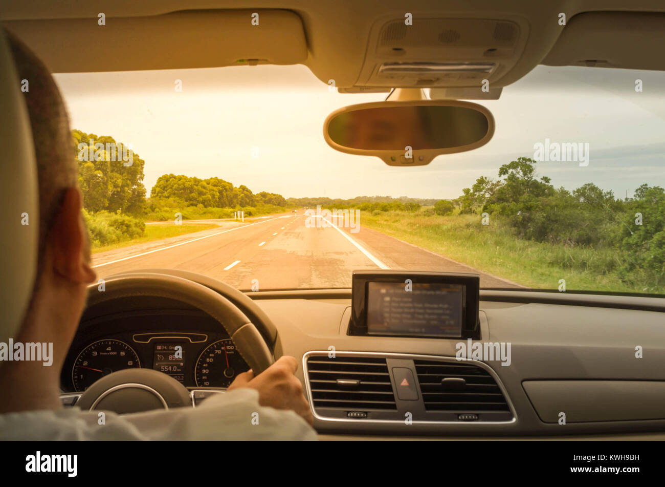Great concept of car trip, man driving car with rear passenger view ...