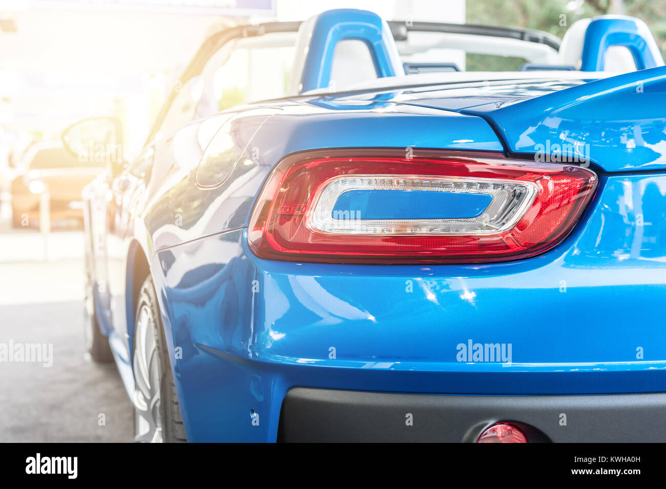 Back of a blue sport car in sunset background Stock Photo - Alamy